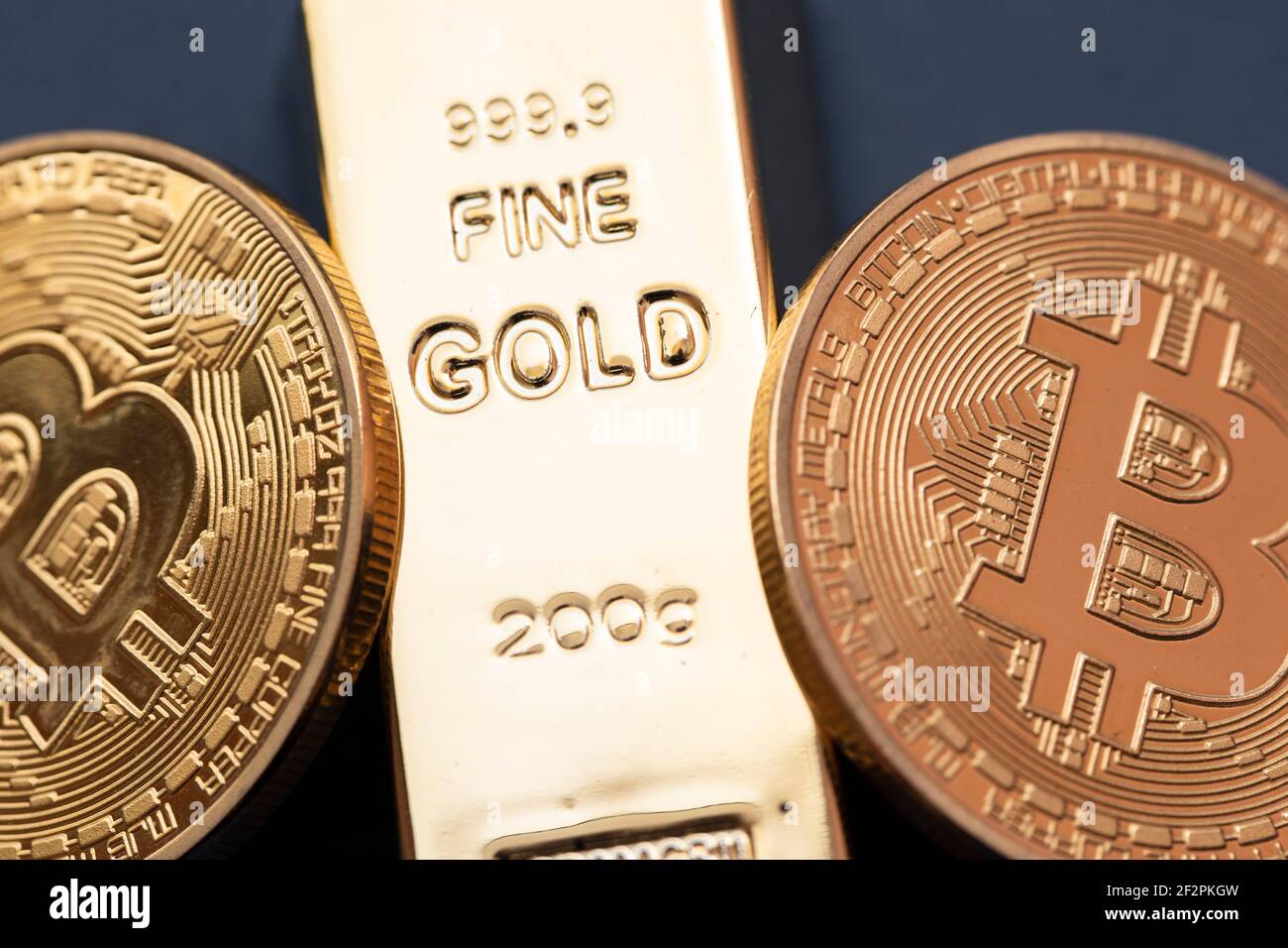 Bitcoin cryptocurrency coin with a gold bullion bar. Investment concept ...