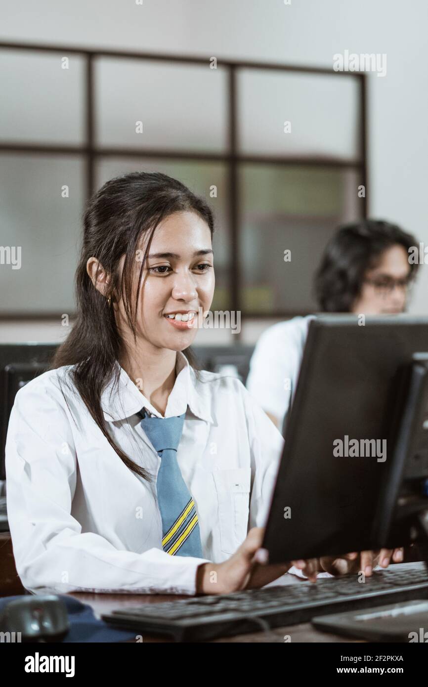female high school students smile while using a computer pc Stock Photo ...