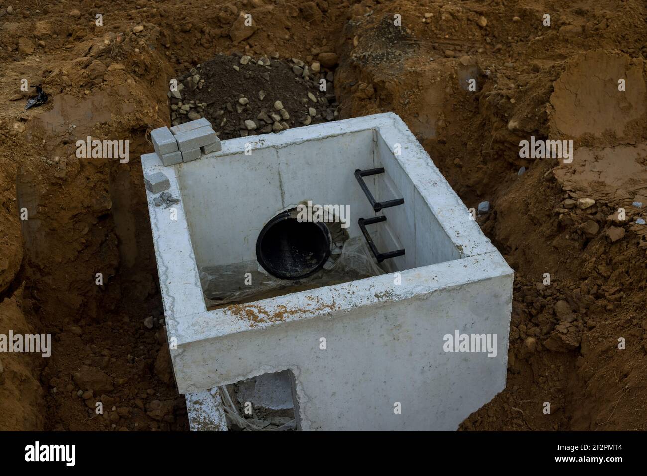 Water drainage at road construction site the square concrete manholes ...