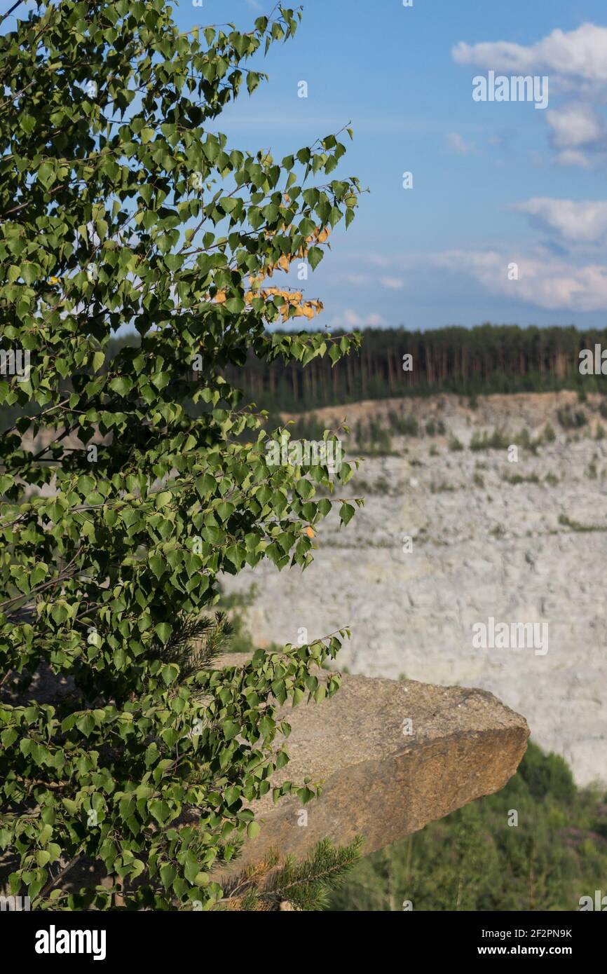 Quarry view. Landscape trees, rock and blue sky Stock Photo - Alamy