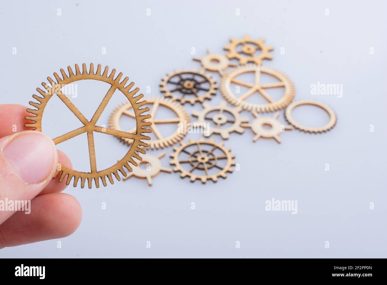 Hand holding gear wheels as the concept of mechanism Stock Photo - Alamy