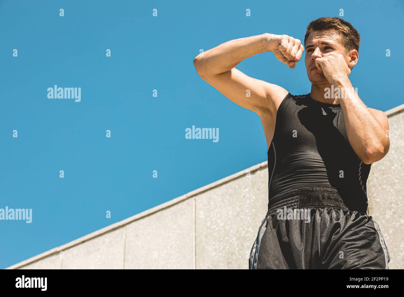 Man exercising and fighting in outside, boxer in gloves. male boxer ...