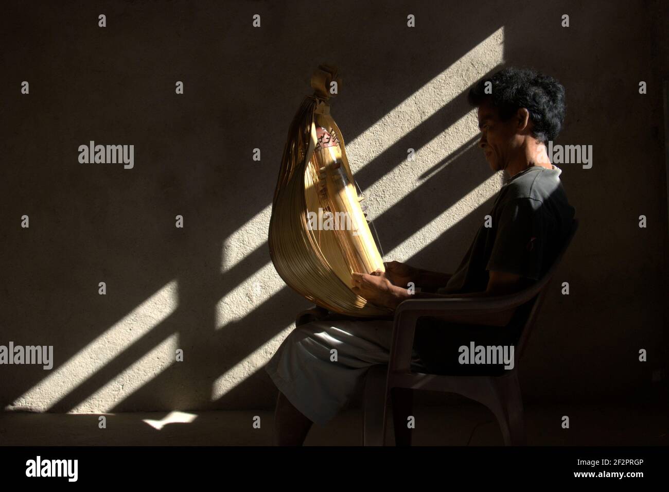 Hance Pah posing for a photo with an electric sasando, Rote Island's ...