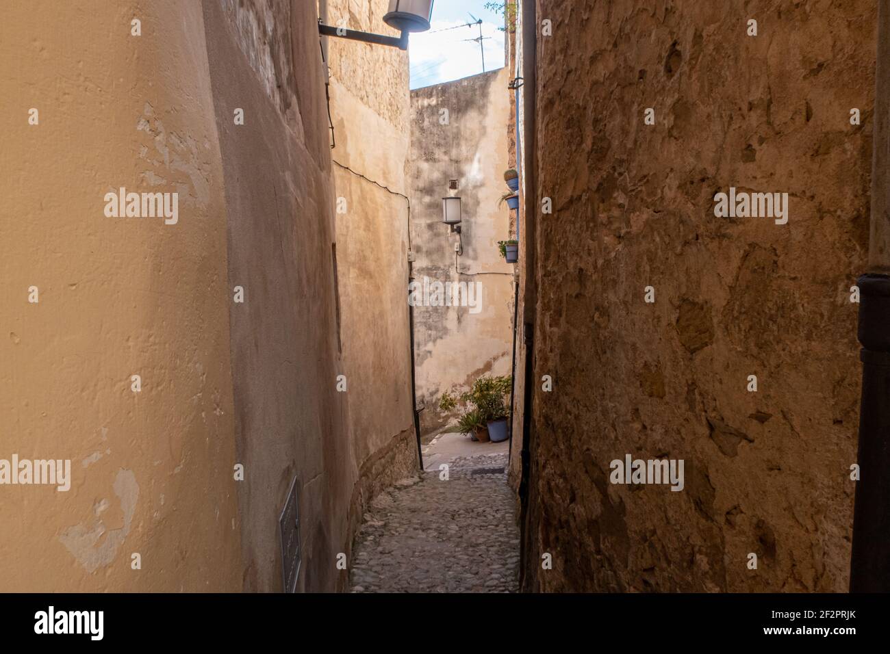A narrow alley in between old stone houses Stock Photo - Alamy
