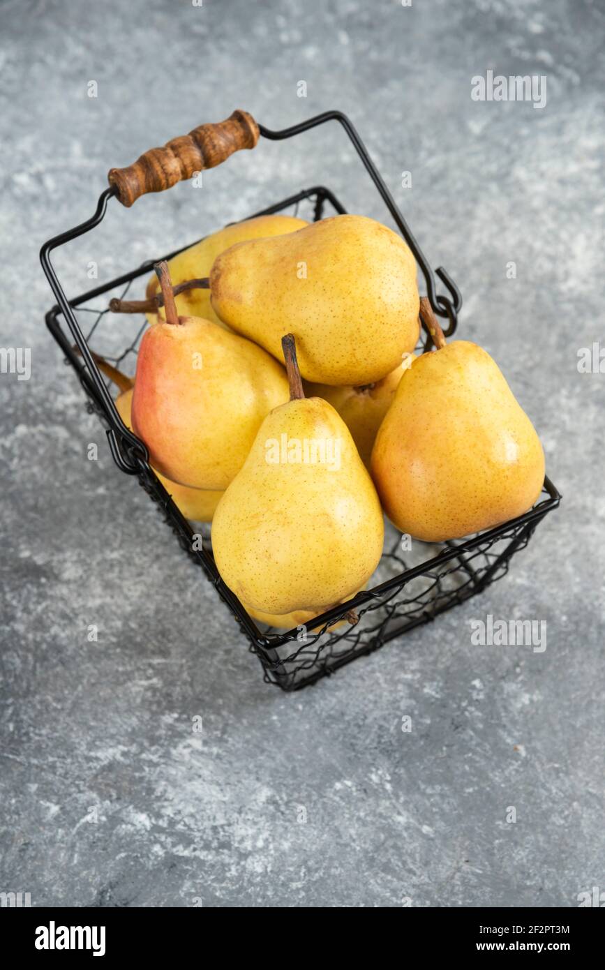 Pile of fresh yellow pears in metal bucket on marble surface Stock ...
