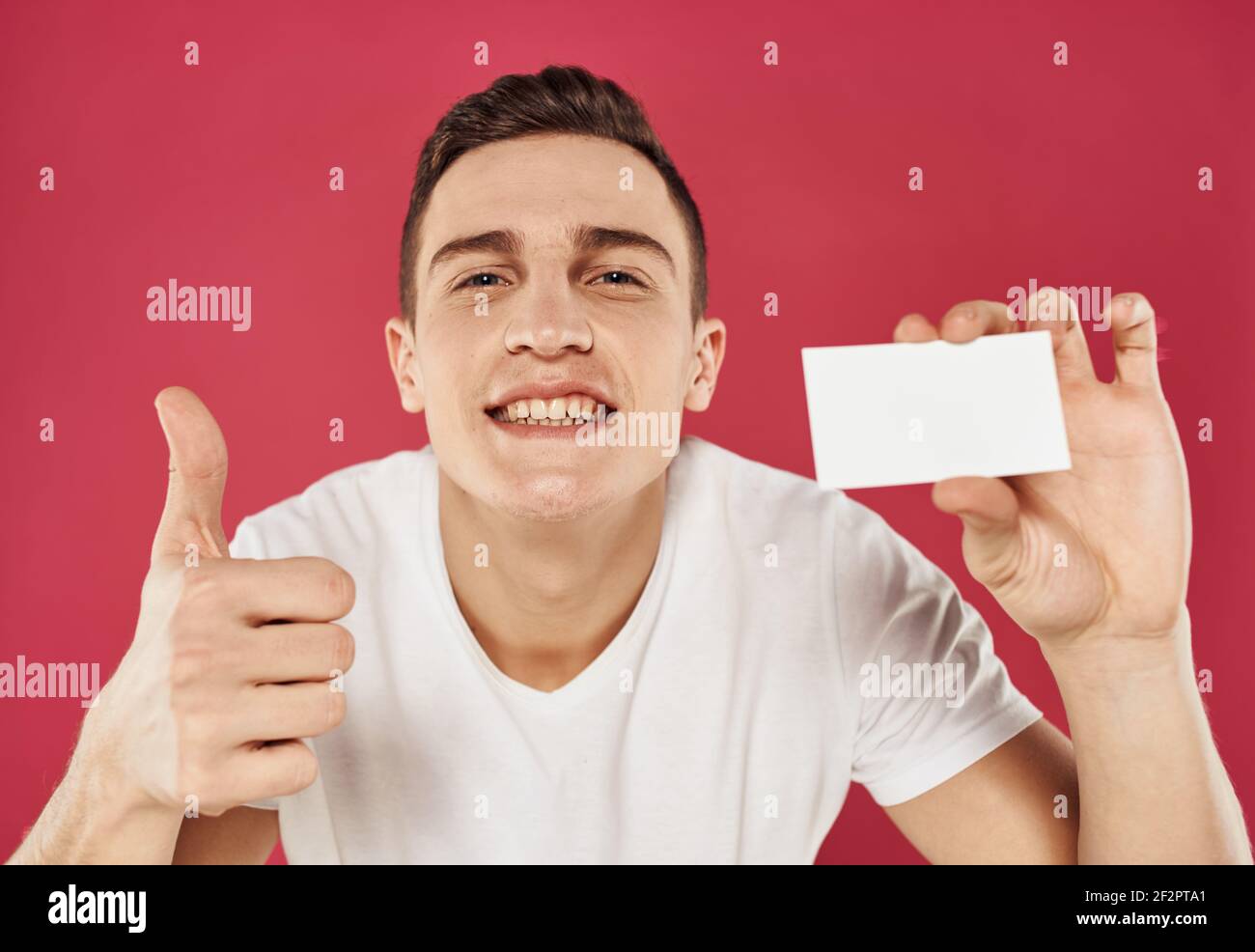 A guy with a business card in his hand gestures and emotions red ...