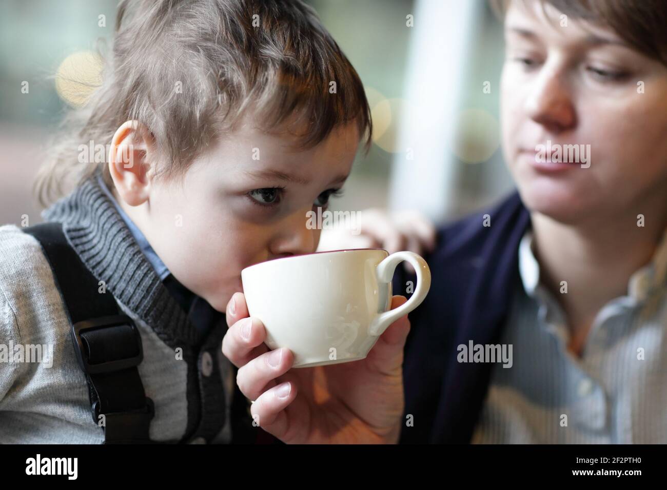 The kid has tea in the restaurant Stock Photo - Alamy