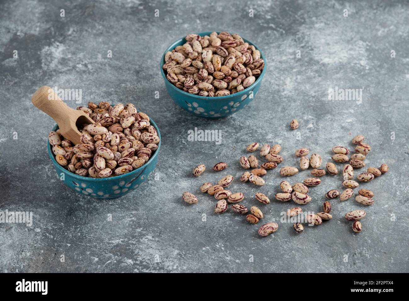 Raw bean grains displayed in bowls on marble surface Stock Photo - Alamy
