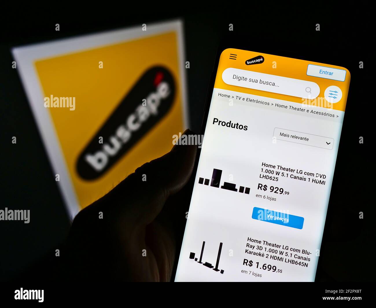 Person holding mobile phone with business logo of Brazilian online shop ...