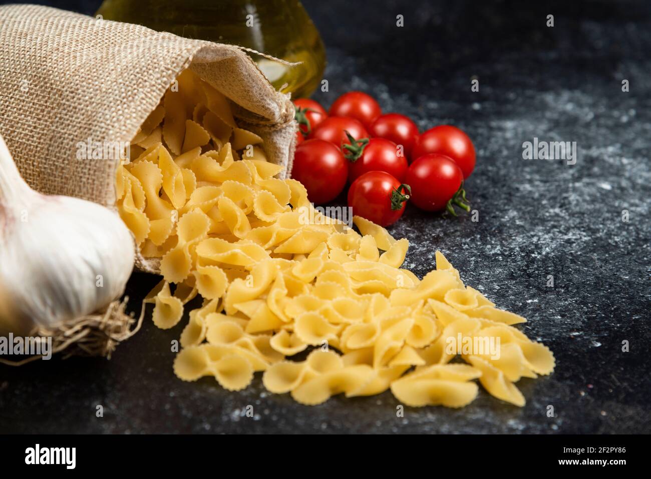 Pasta basket with olive oil, cherry tomatoes and garlic around Stock ...