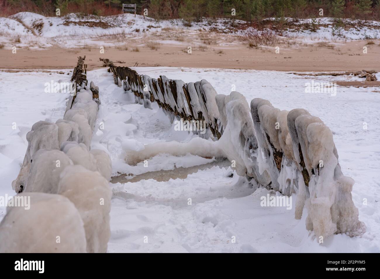 ancient boat docks with ice covered in winter and sea water washing the ...