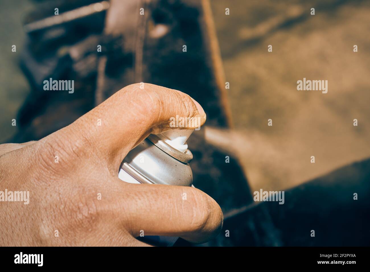 Zoom Hand Car Mechanic or Auto Mechanic Spray Paint Car Chassis in ...