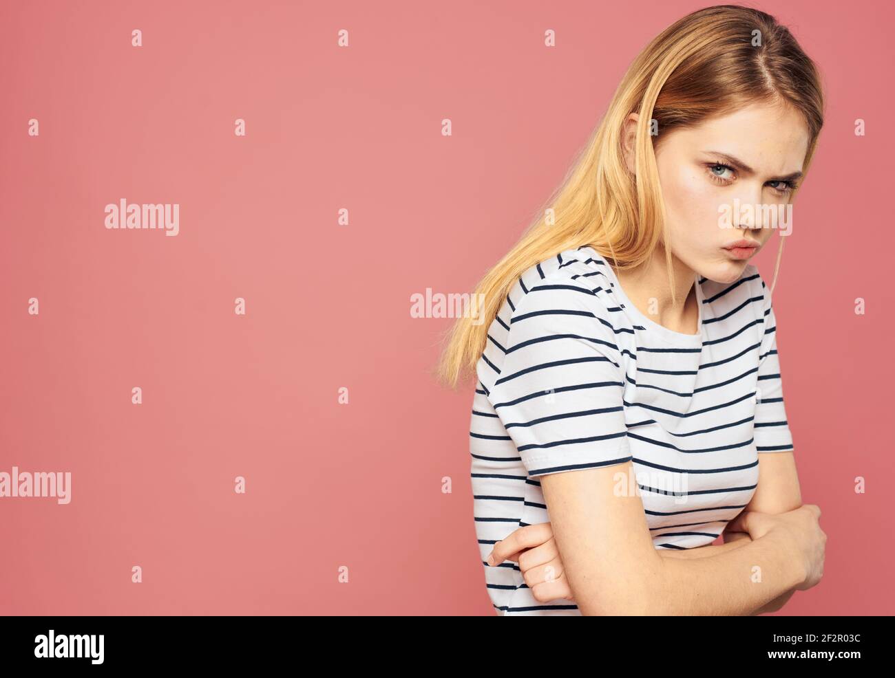 Upset woman offended face pink background cropped view model Stock ...