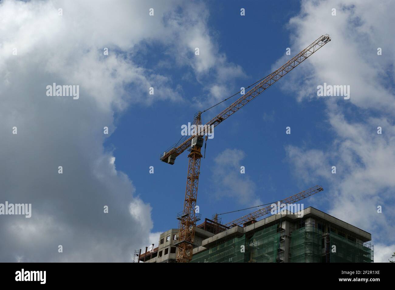 Elevating construction crane Stock Photo - Alamy
