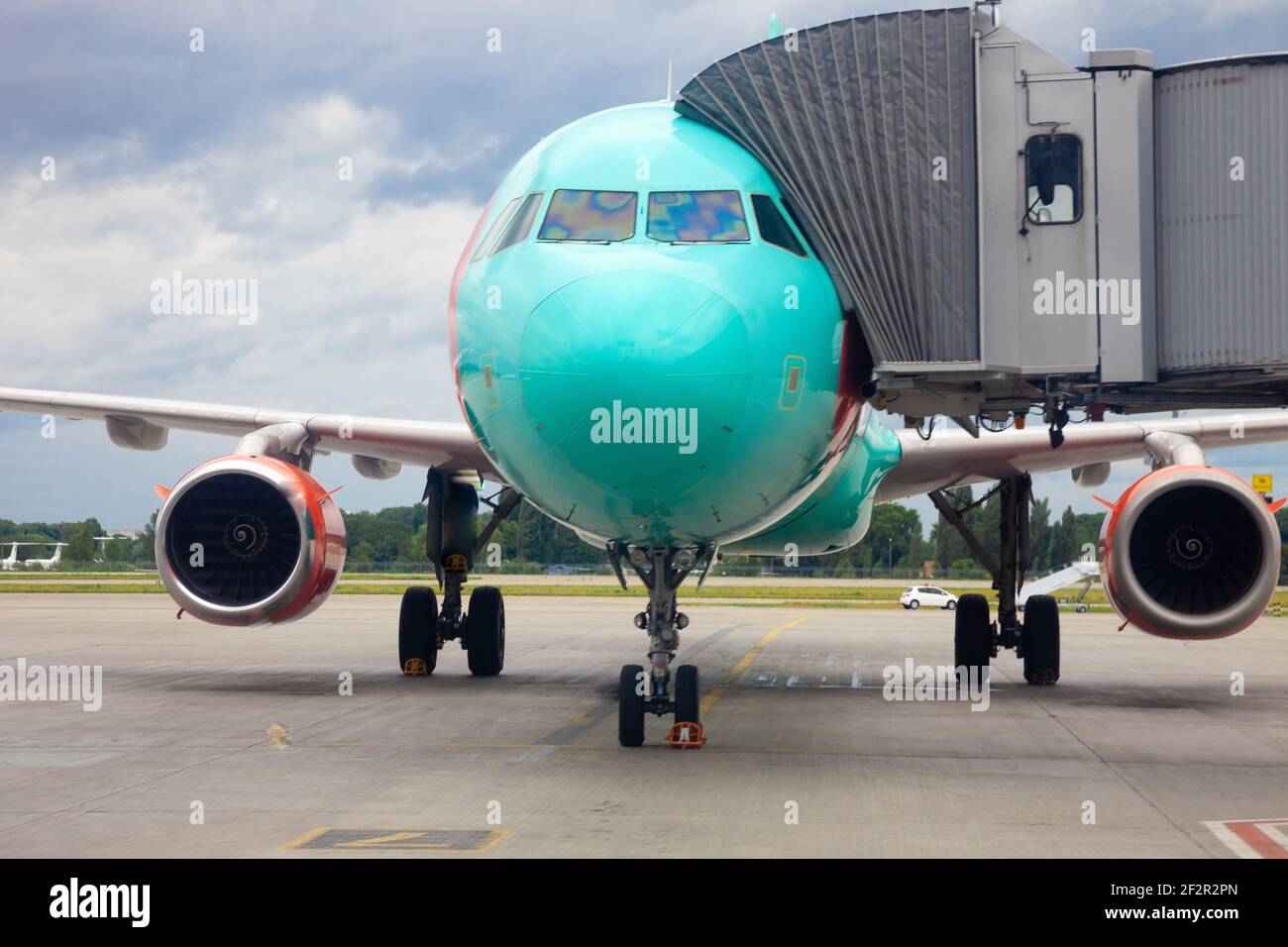 Passenger plane at the airport. Boarding passengers through the ...
