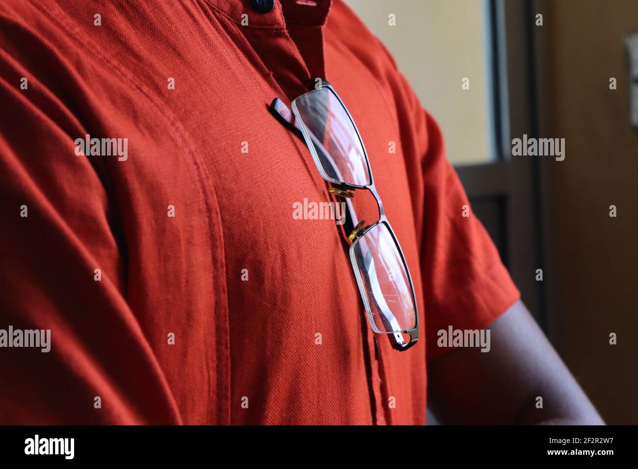 The spectacles are released from the eyes but hanging on the chest with ...