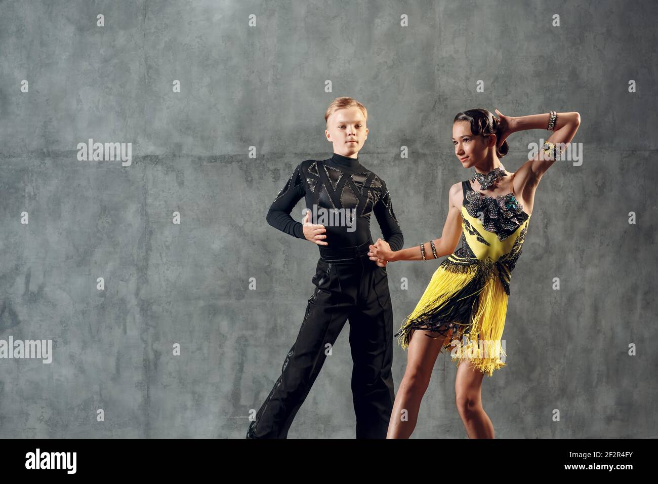 Young couple dancers dancing ballroom dance cha-cha-cha Stock Photo - Alamy