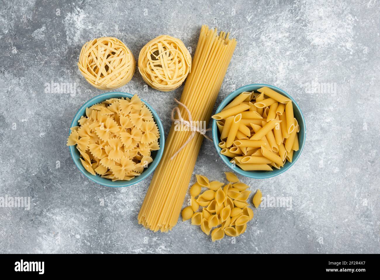 Raw pasta and spaghetti varieties on marble background Stock Photo - Alamy