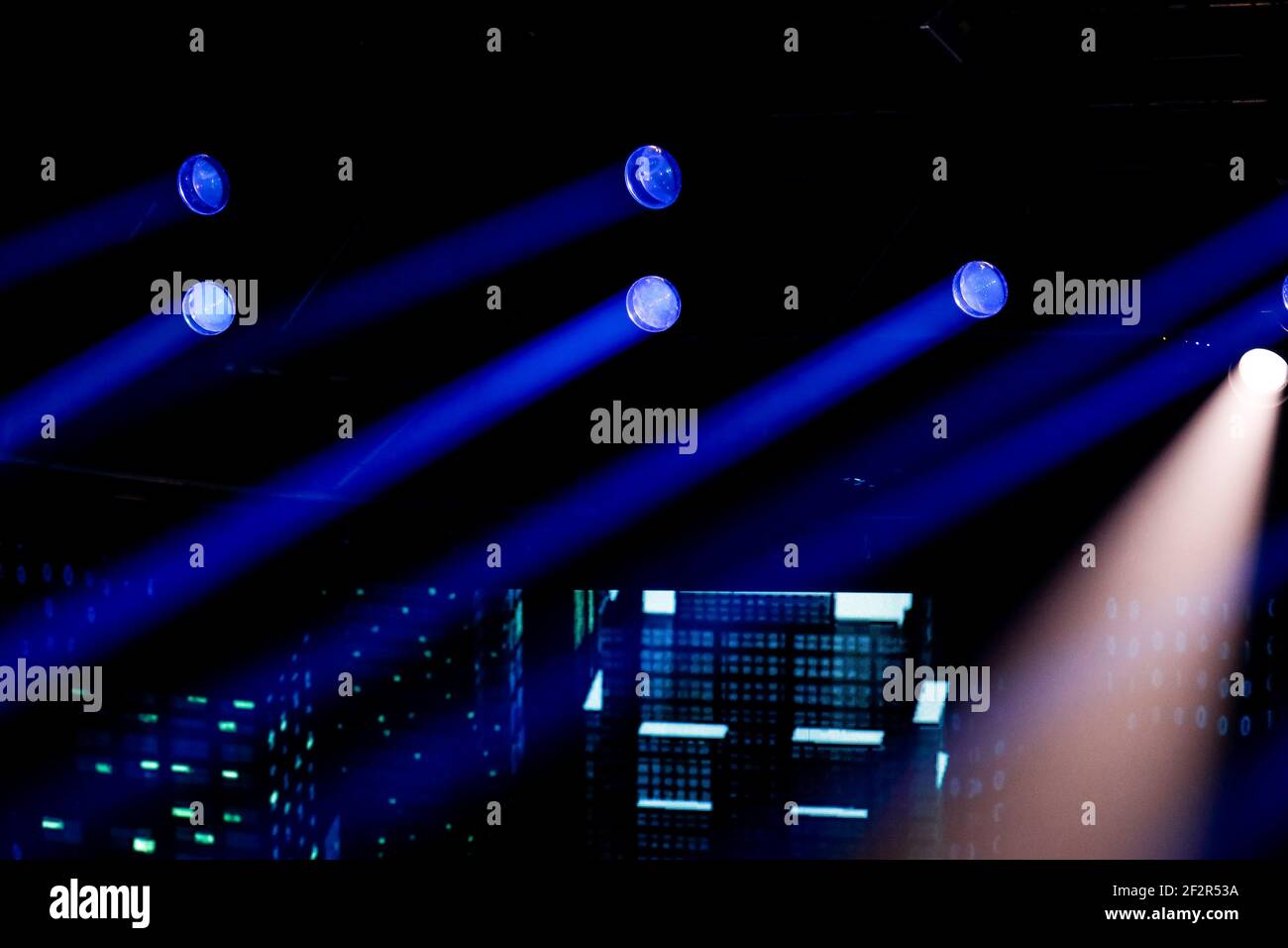 Blue light spotlights on the concert stage in evening Stock Photo - Alamy