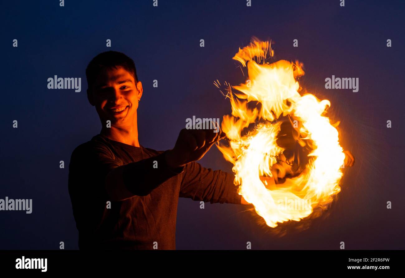 Man fire spinning poi hi-res stock photography and images - Alamy