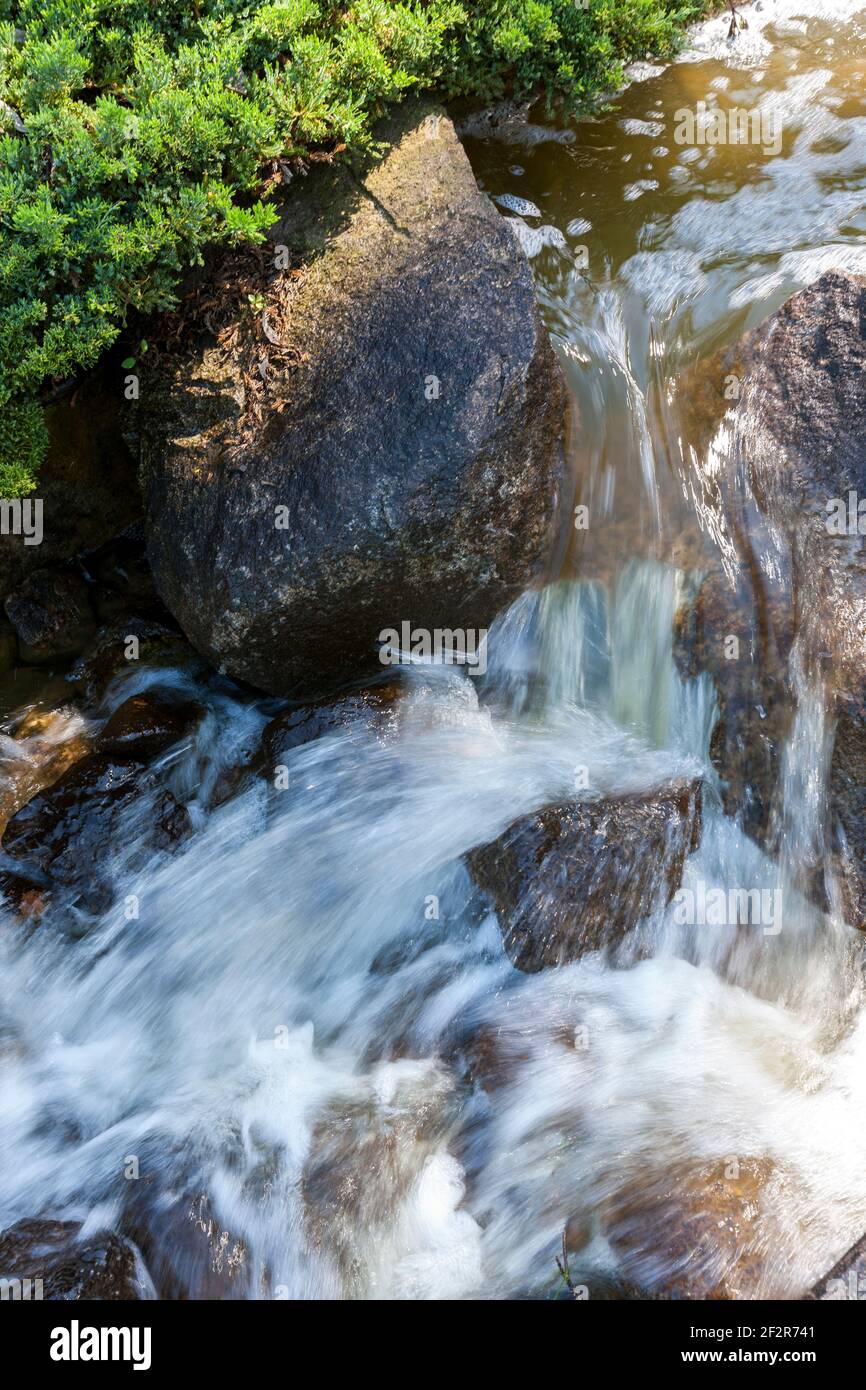 Water flowing between rocks Stock Photo - Alamy