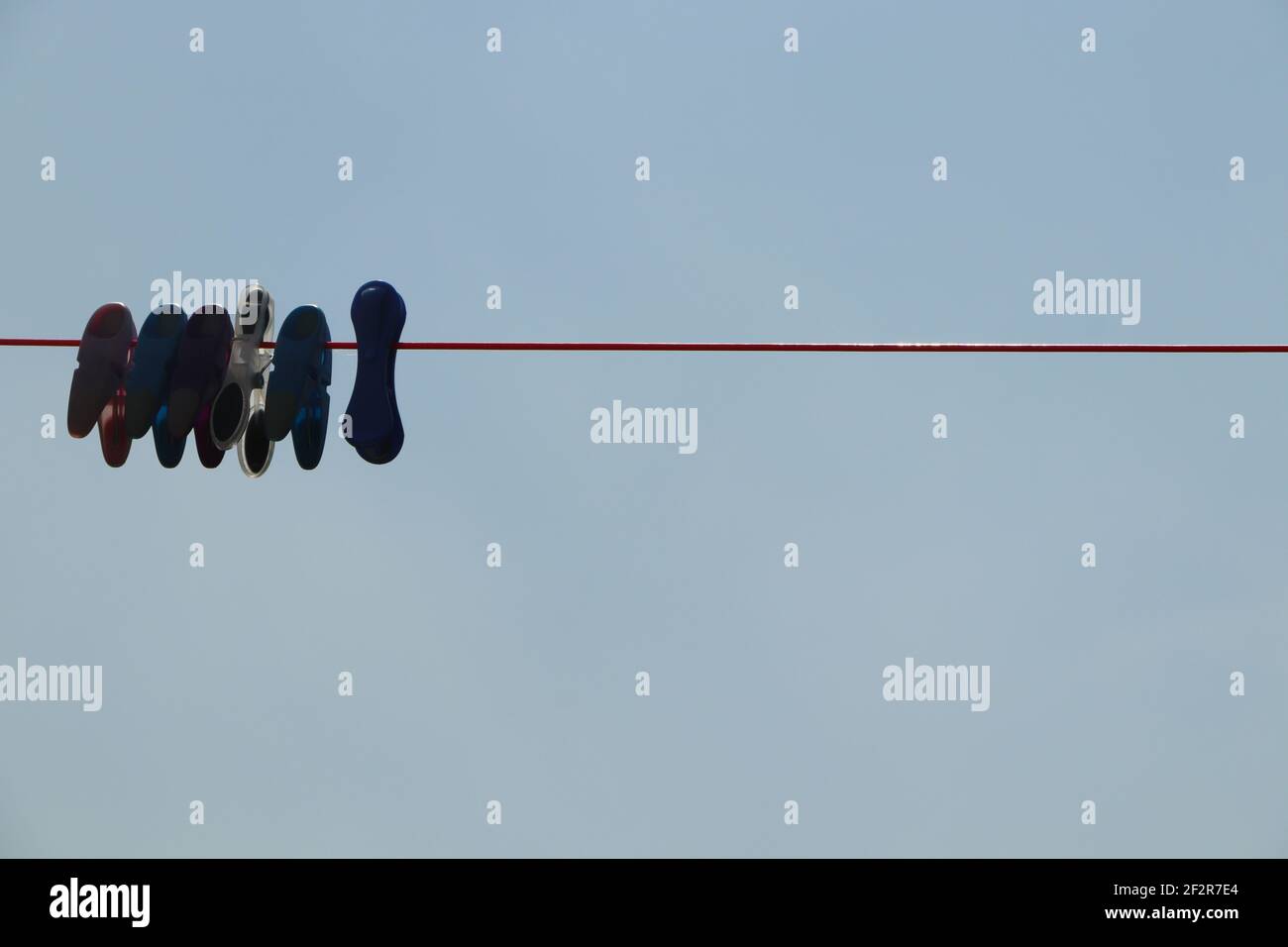 Silhouette of pegs hanging from a washing line at dusk Stock Photo - Alamy
