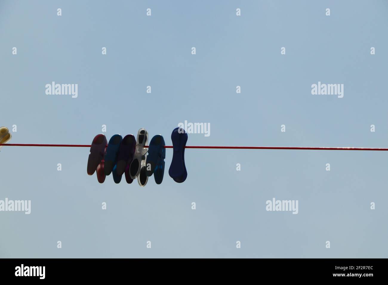 Silhouette of pegs hanging from a washing line at dusk Stock Photo - Alamy