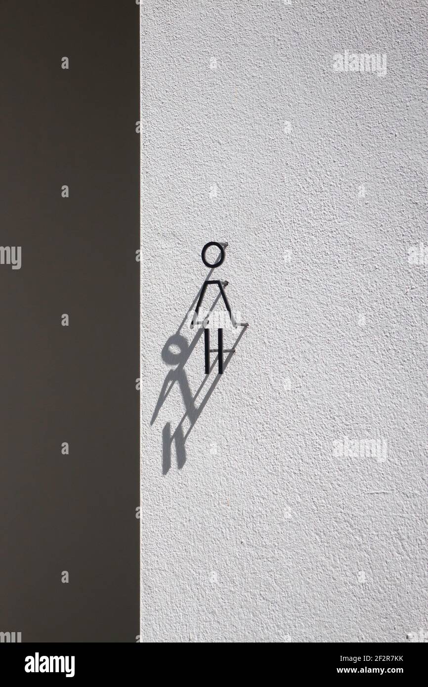 Modern sign shadow of outdoor toilet Stock Photo - Alamy