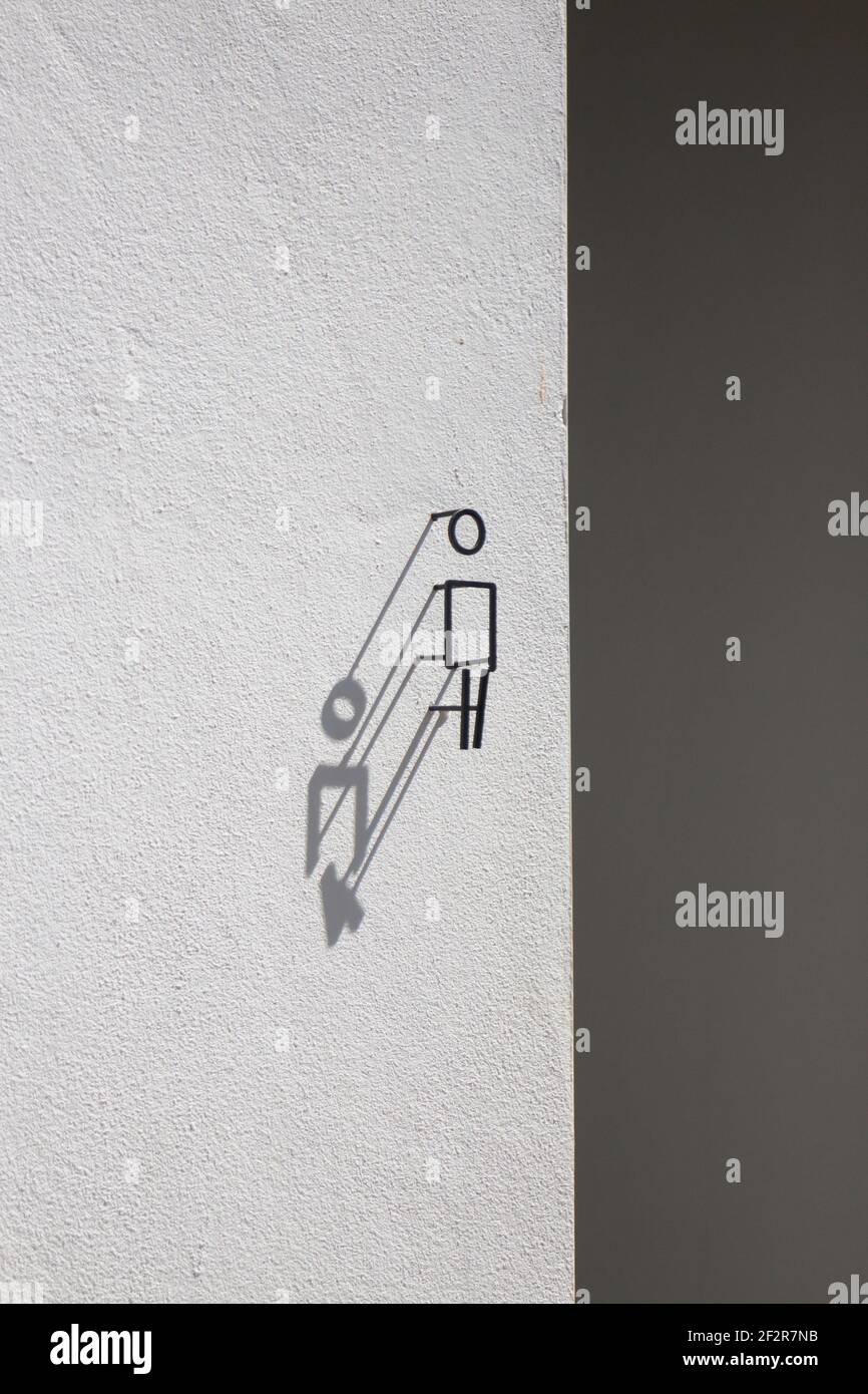 Modern sign shadow of outdoor toilet Stock Photo - Alamy