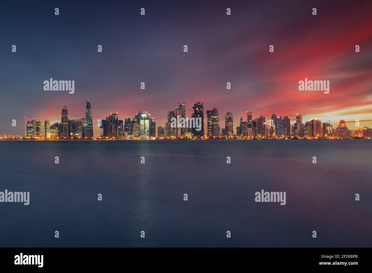 The skyline of Doha, Qatar after sunset Stock Photo - Alamy