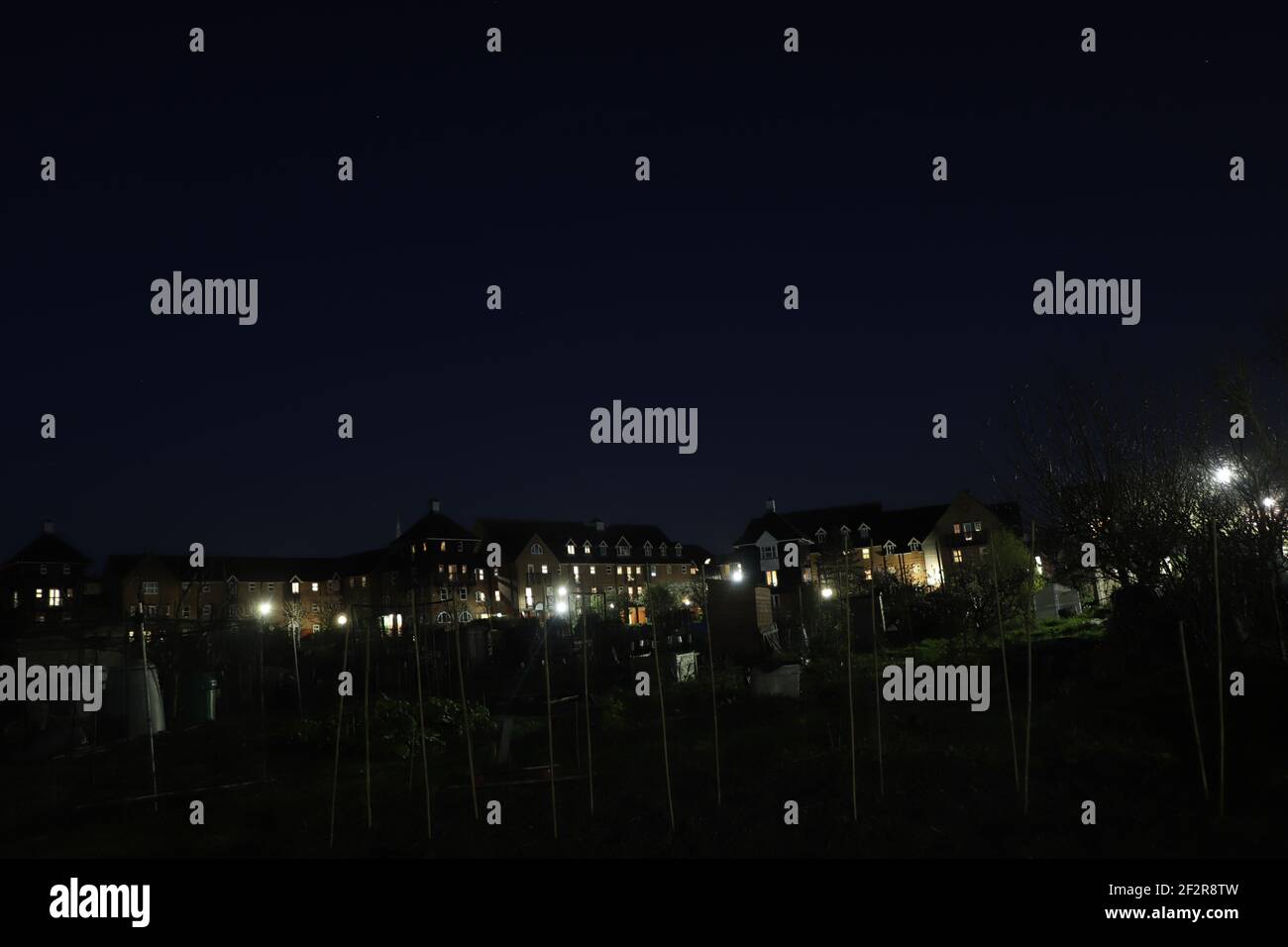 Night sky and garden lit up with halogen and solar lights Stock Photo ...