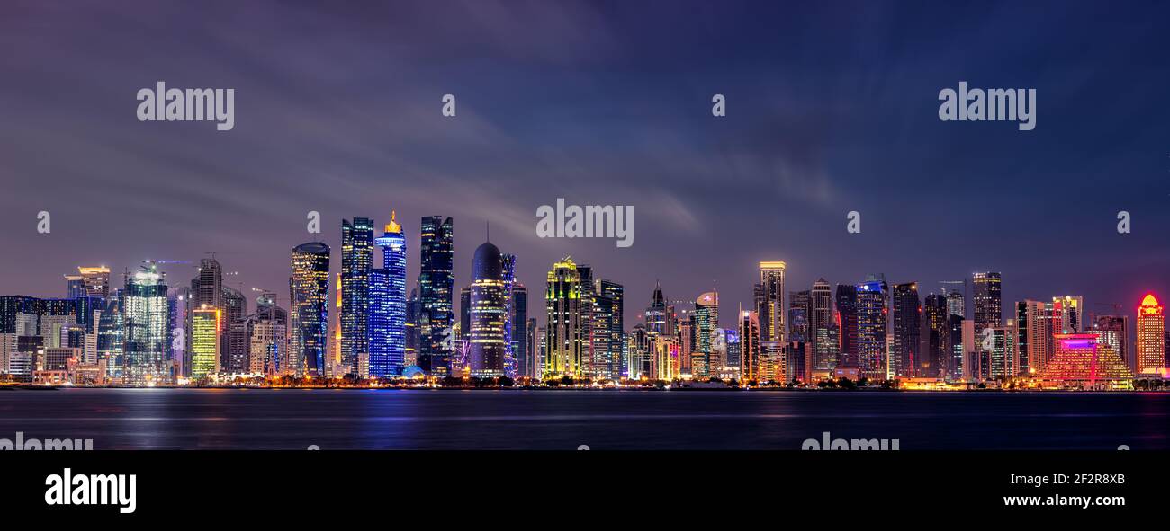 The skyline of Doha, Qatar after sunset Stock Photo - Alamy