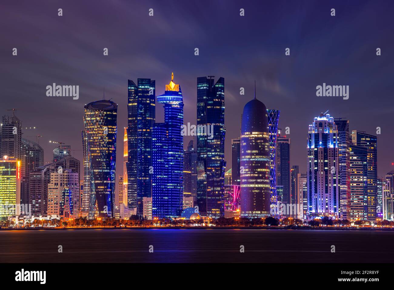 The skyline of Doha, Qatar after sunset Stock Photo - Alamy
