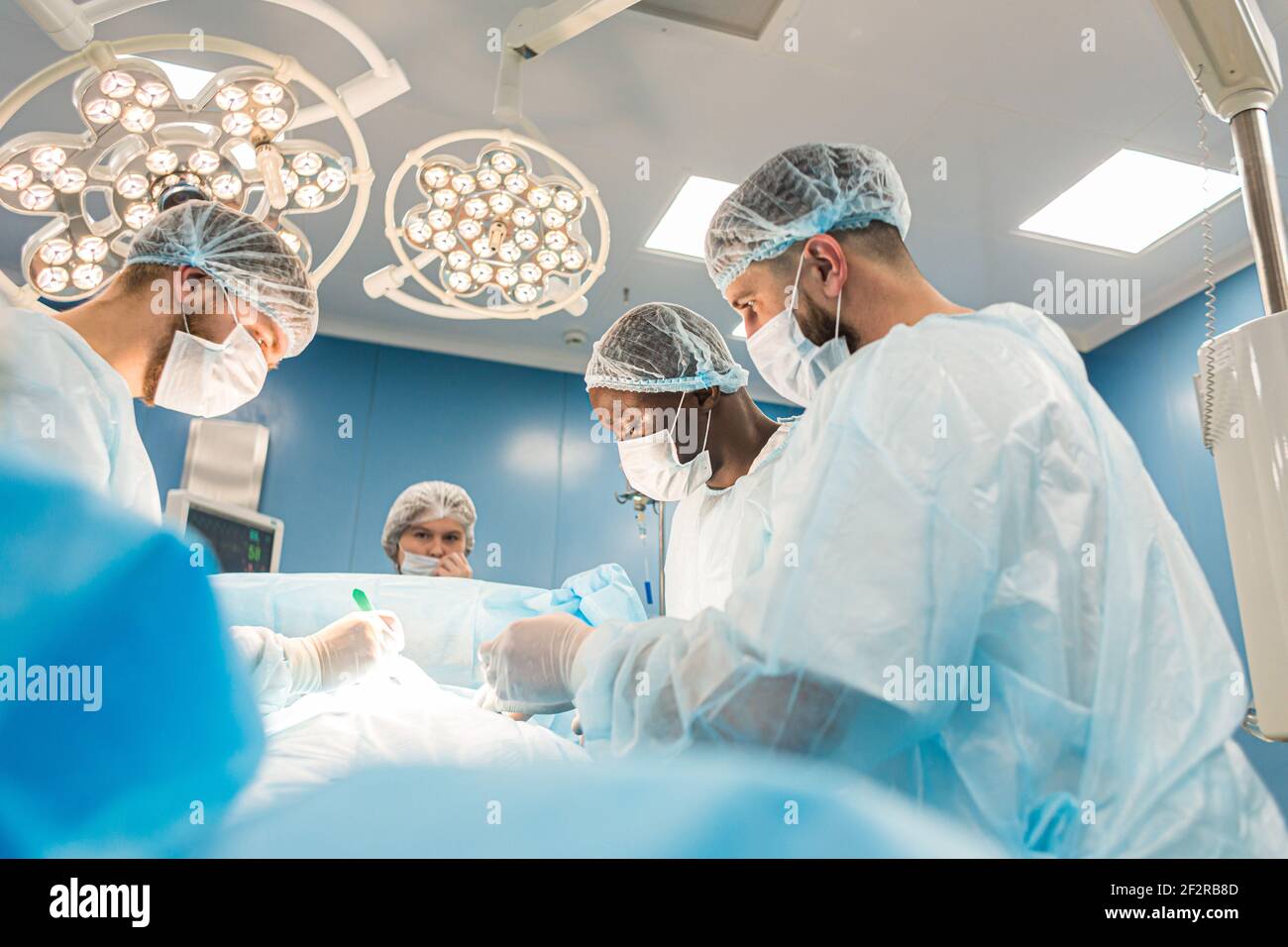 The senior surgeon in the operating room, where the patient is waiting ...