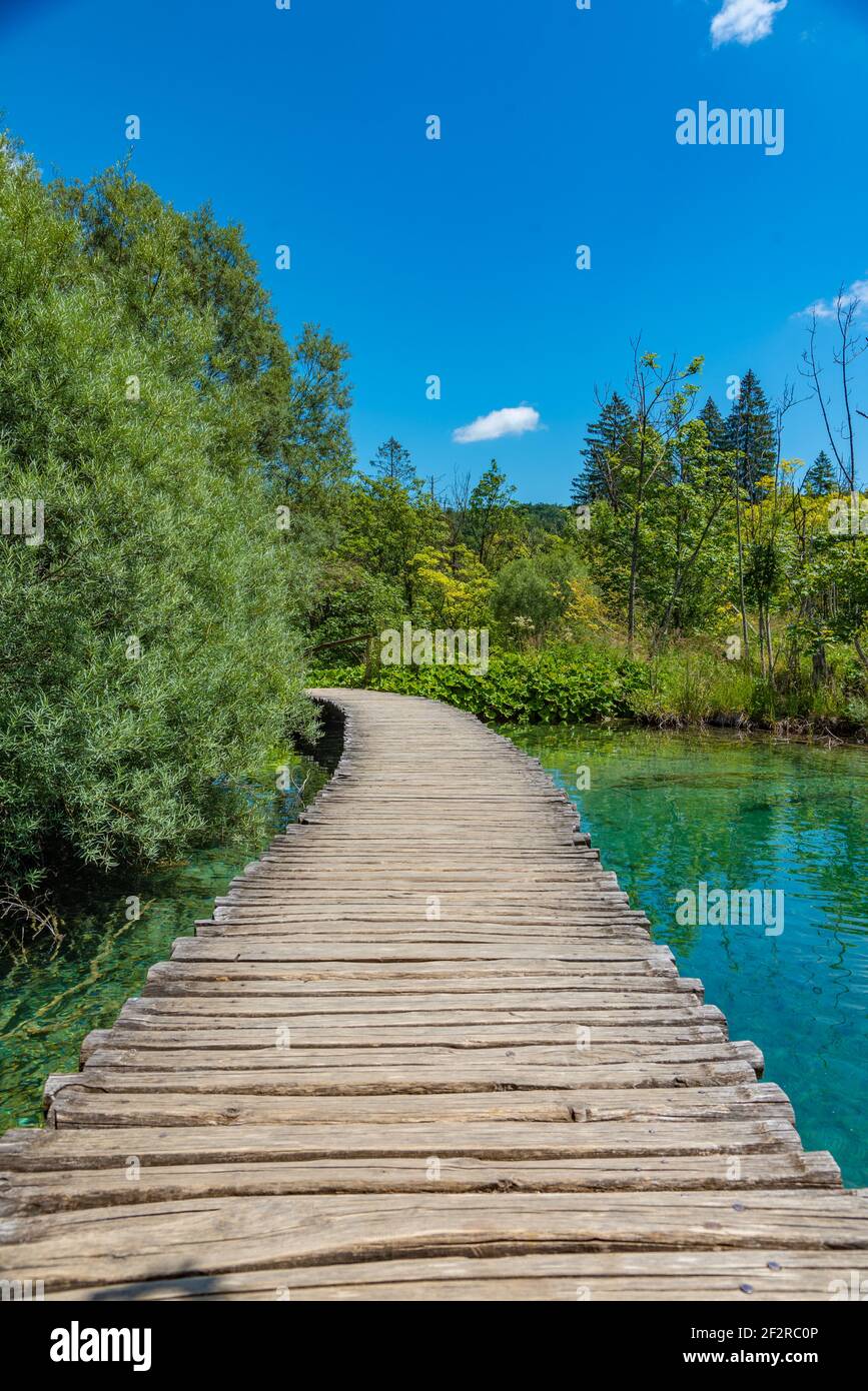 Wooden boardwalk leading through plitvice lakes national park in ...
