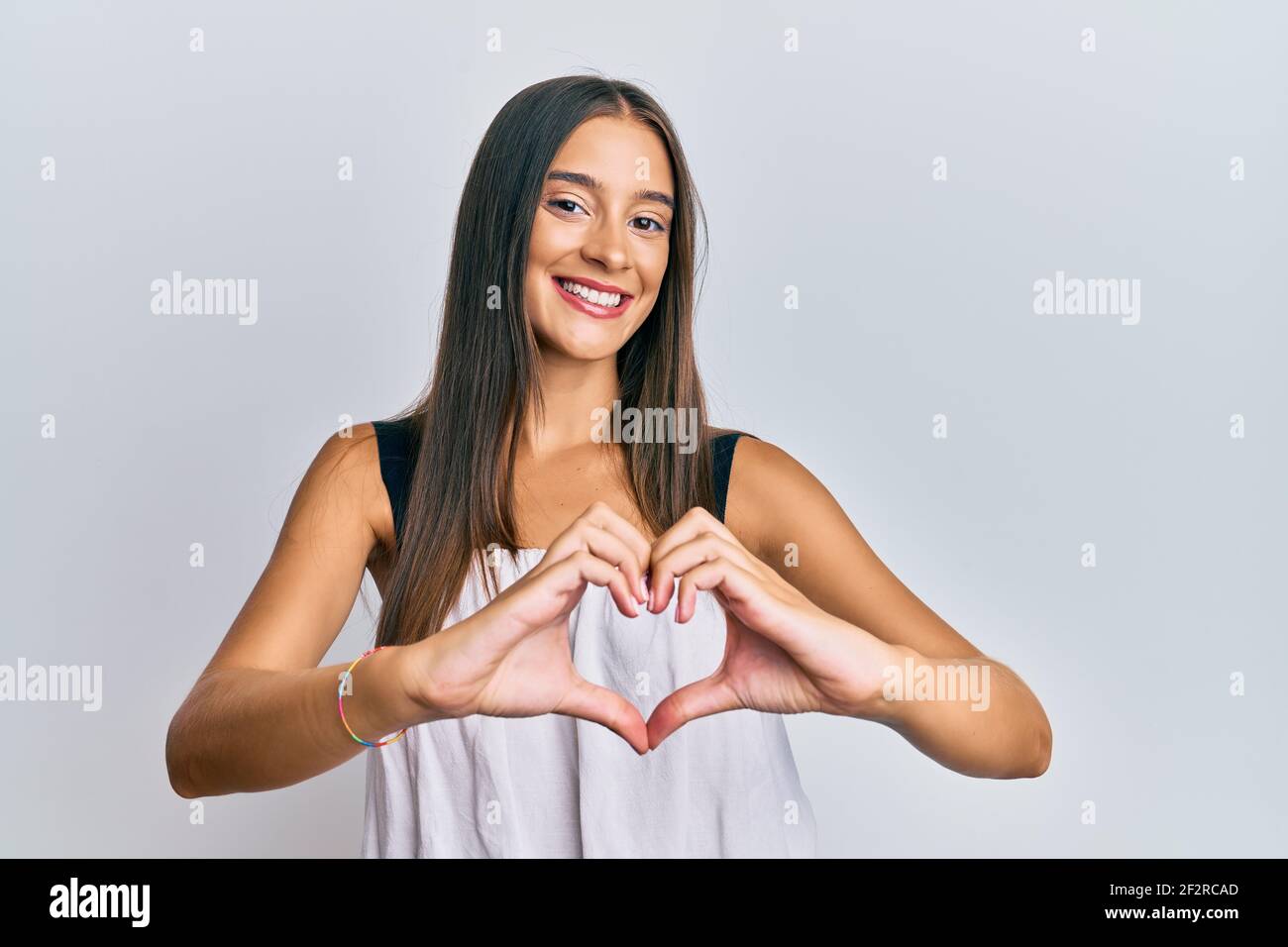 Young hispanic woman wearing casual clothes smiling in love showing ...