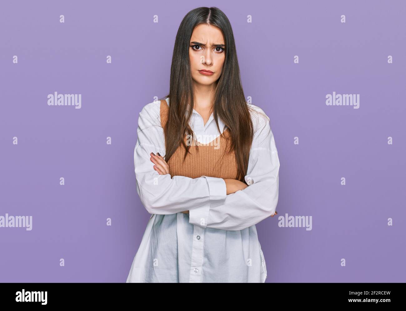 Young beautiful woman wearing casual white shirt skeptic and nervous ...