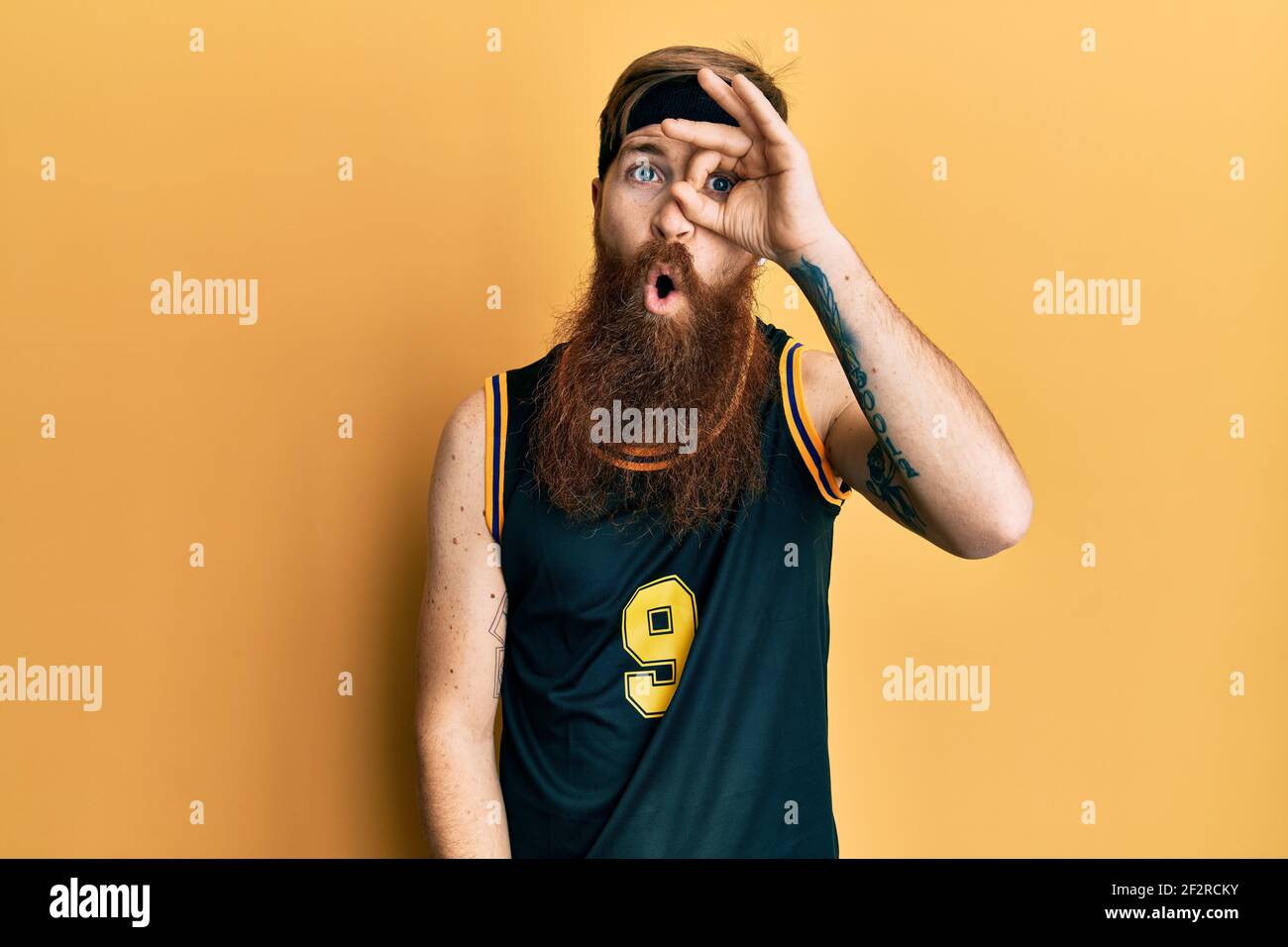 Redhead Man With Long Beard Wearing Basketball Uniform Doing Ok Gesture