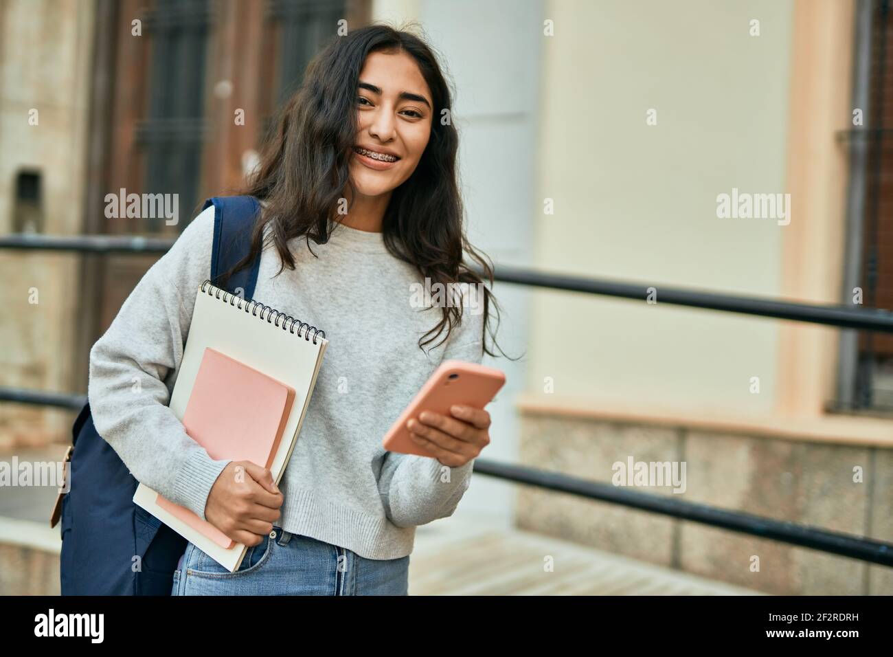 Young middle east student girl smiling happy using smartphone at the ...