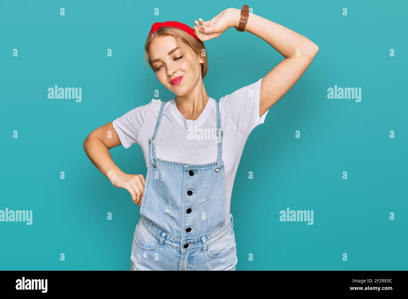 Young caucasian girl wearing casual clothes stretching back, tired and ...