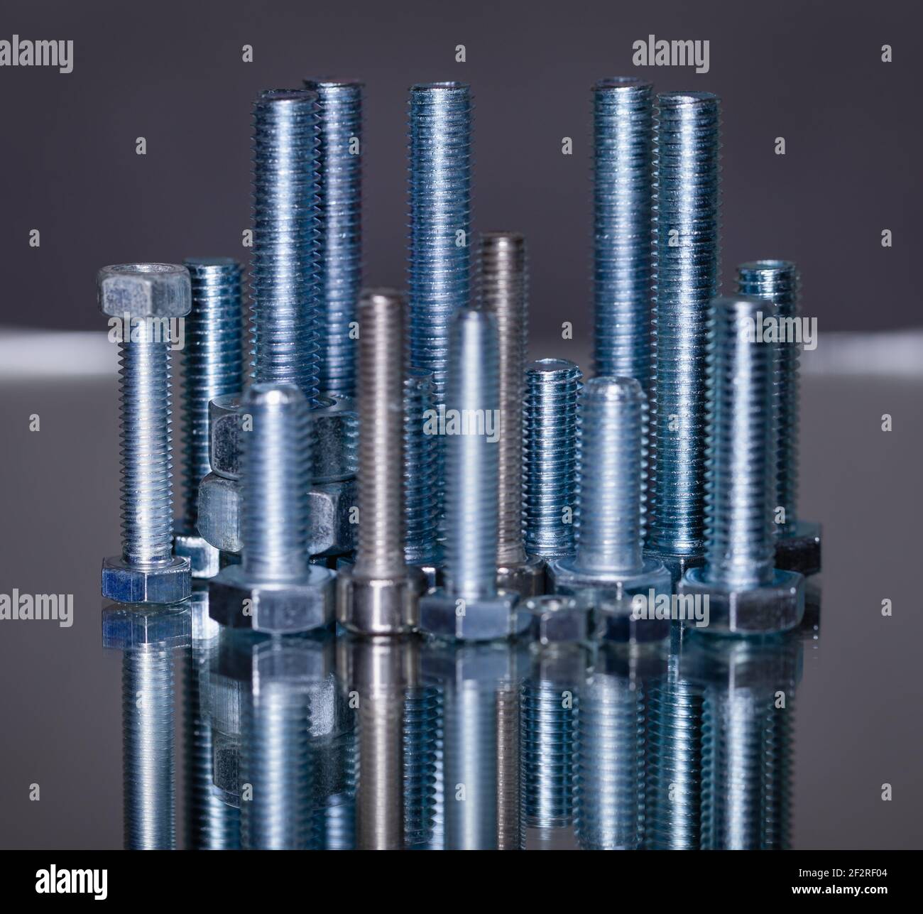Bolts and nuts on a mirror background Stock Photo - Alamy