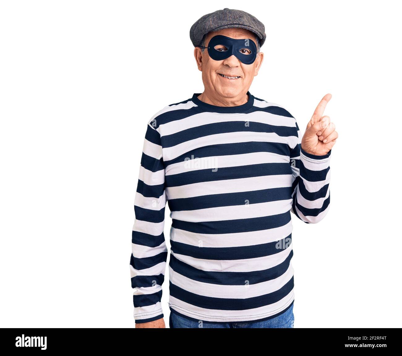 Senior handsome man wearing burglar mask and t-shirt with a big smile ...