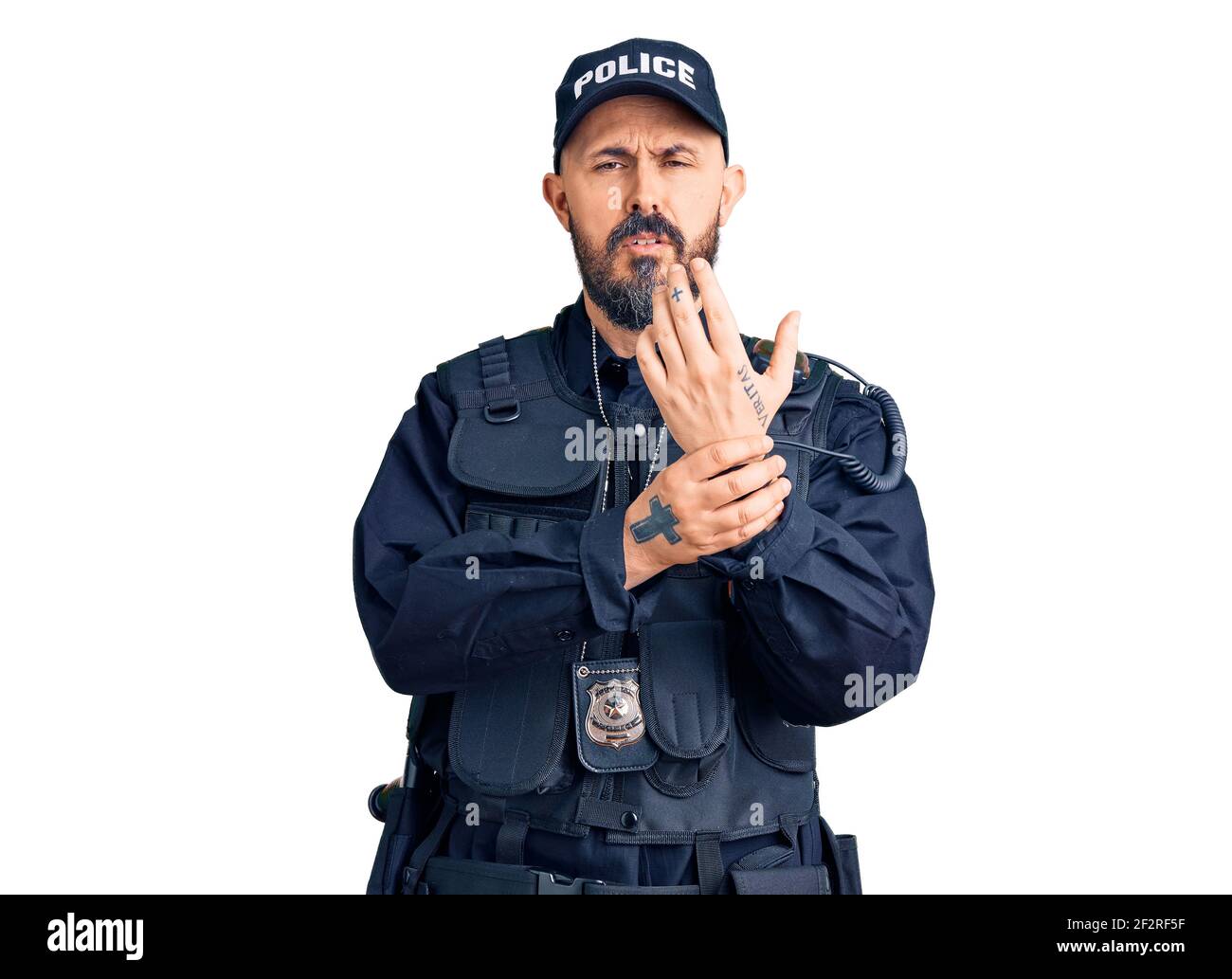 Young handsome man wearing police uniform suffering pain on hands and ...