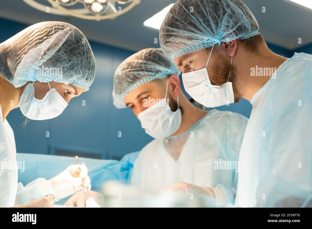 The senior surgeon in the operating room, where the patient is waiting ...