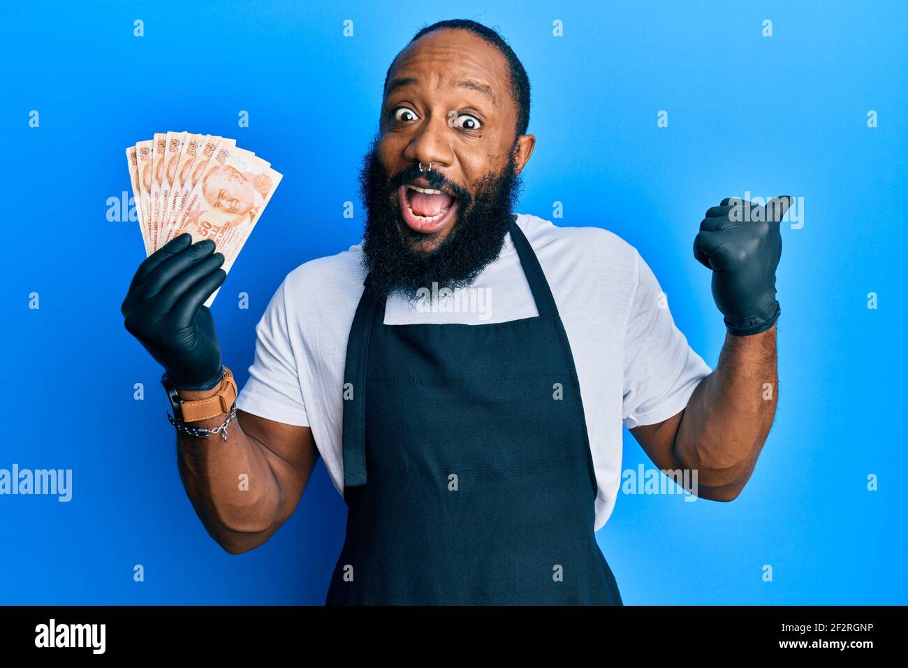 Young african american man wearing professional apron holding turkish ...