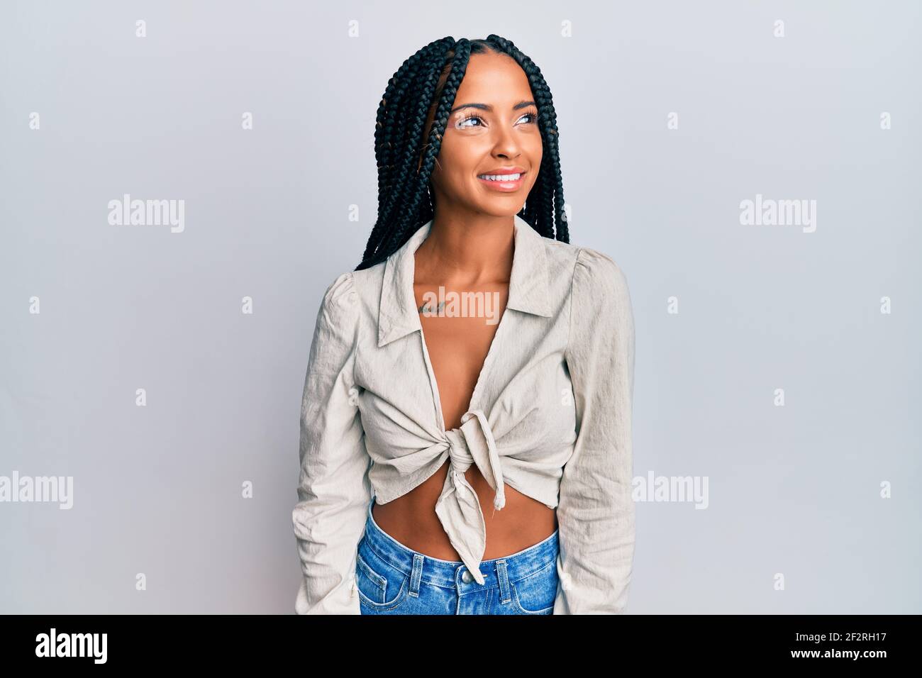 Beautiful hispanic woman wearing casual clothes looking to side, relax ...
