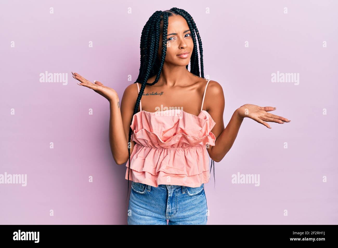 Beautiful hispanic woman wearing casual clothes clueless and confused ...