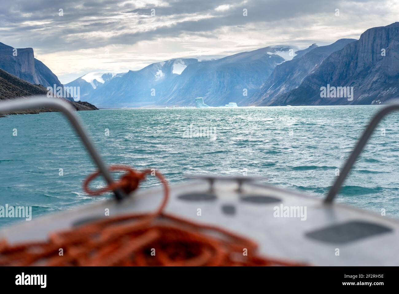North Pangnirtung fjord with steep cliffs and icebergs floating in the ...