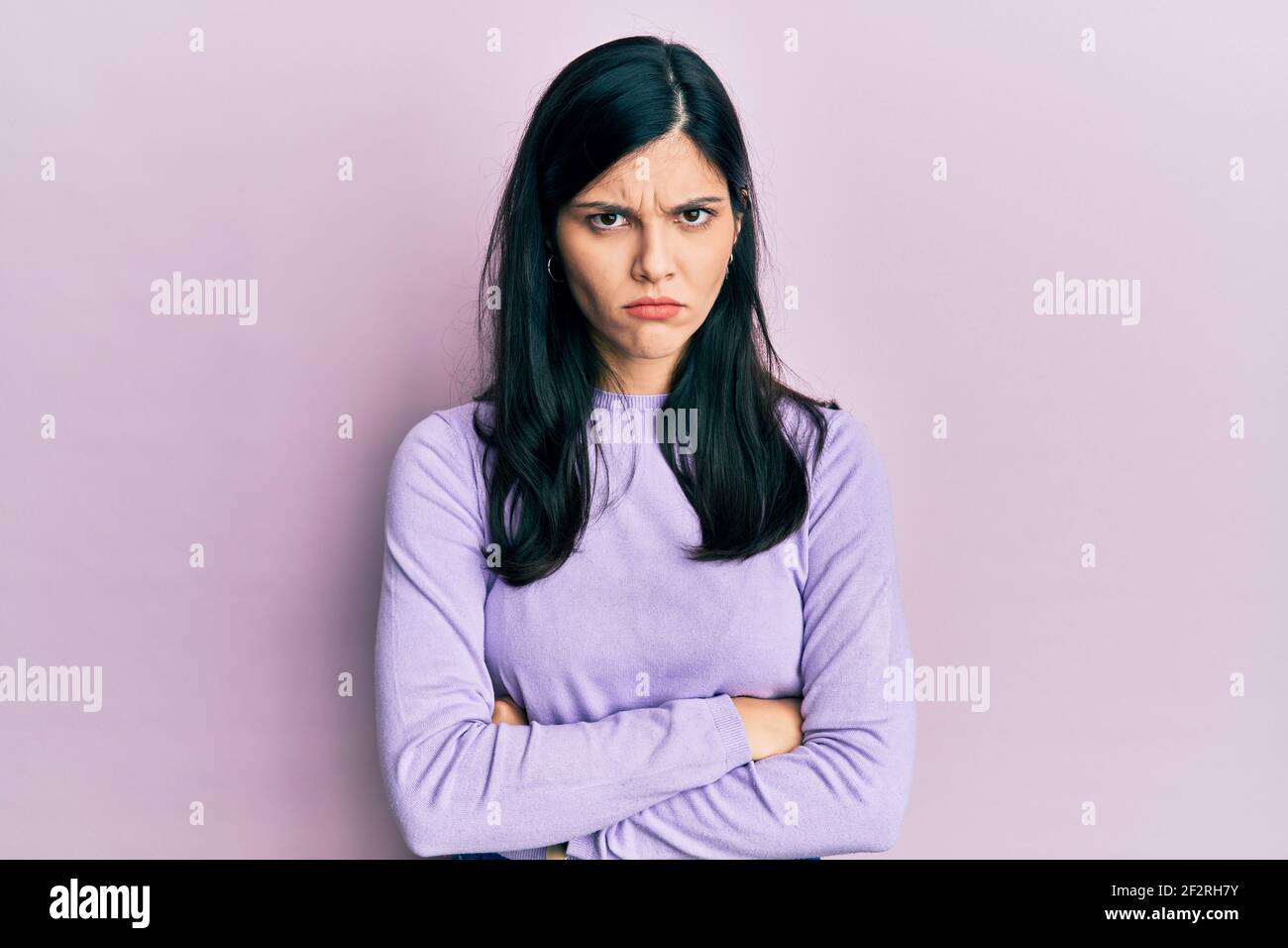 Young hispanic woman wearing casual clothes skeptic and nervous ...