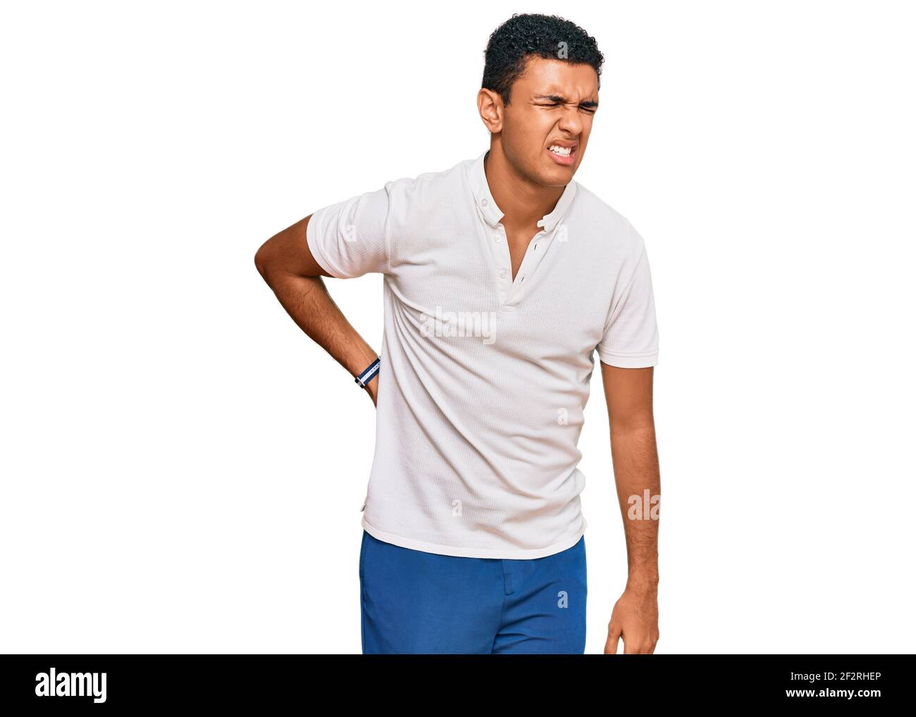 Young arab man wearing casual clothes suffering of backache, touching ...